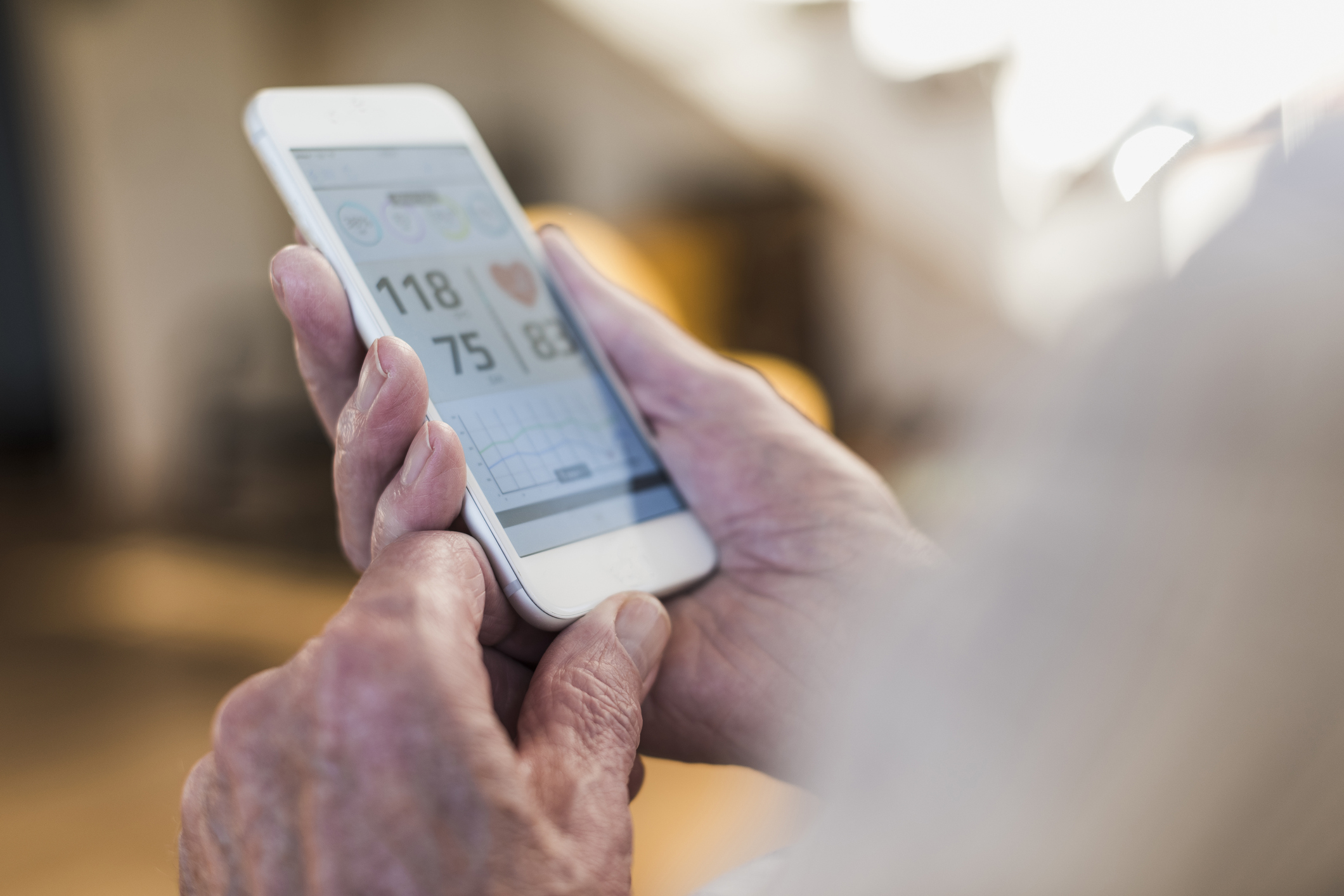 Senior man using smart phone app - LivingBetter50